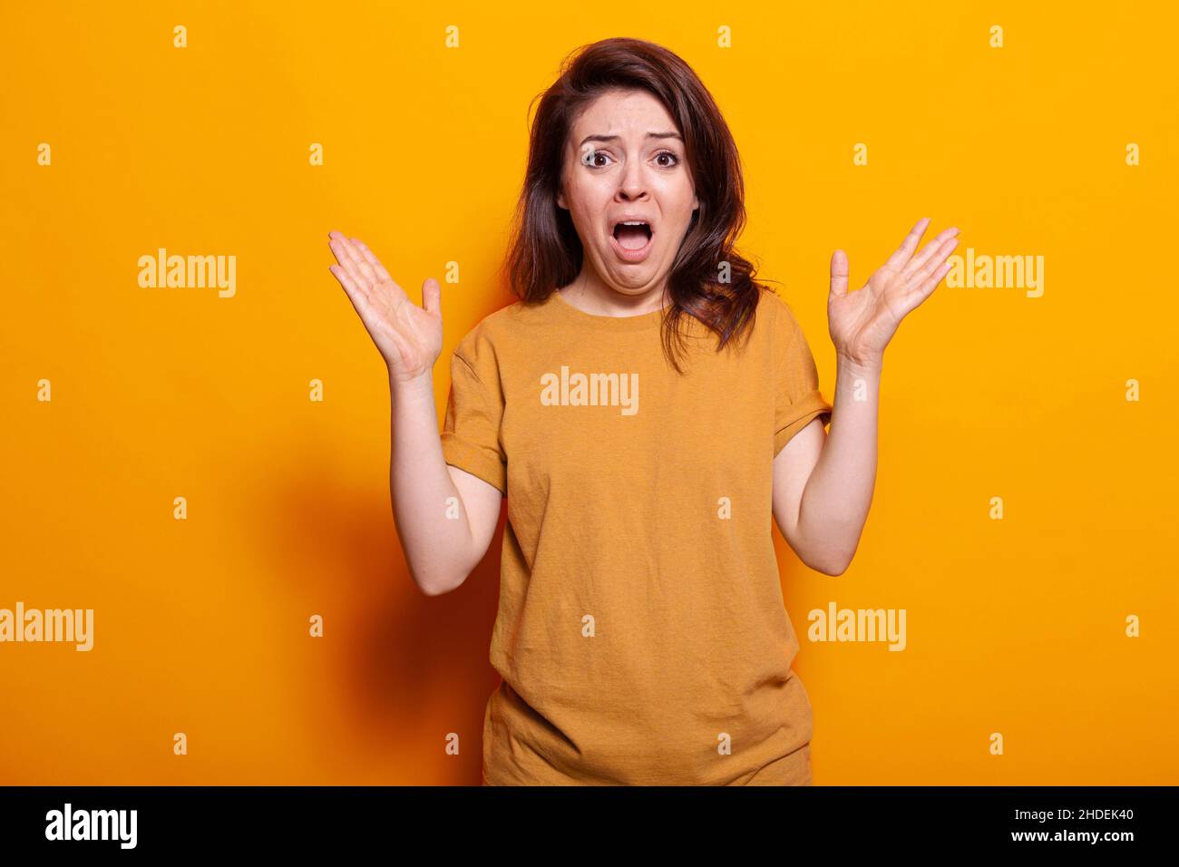 Frightened person showing shocked facial expression, standing over ...