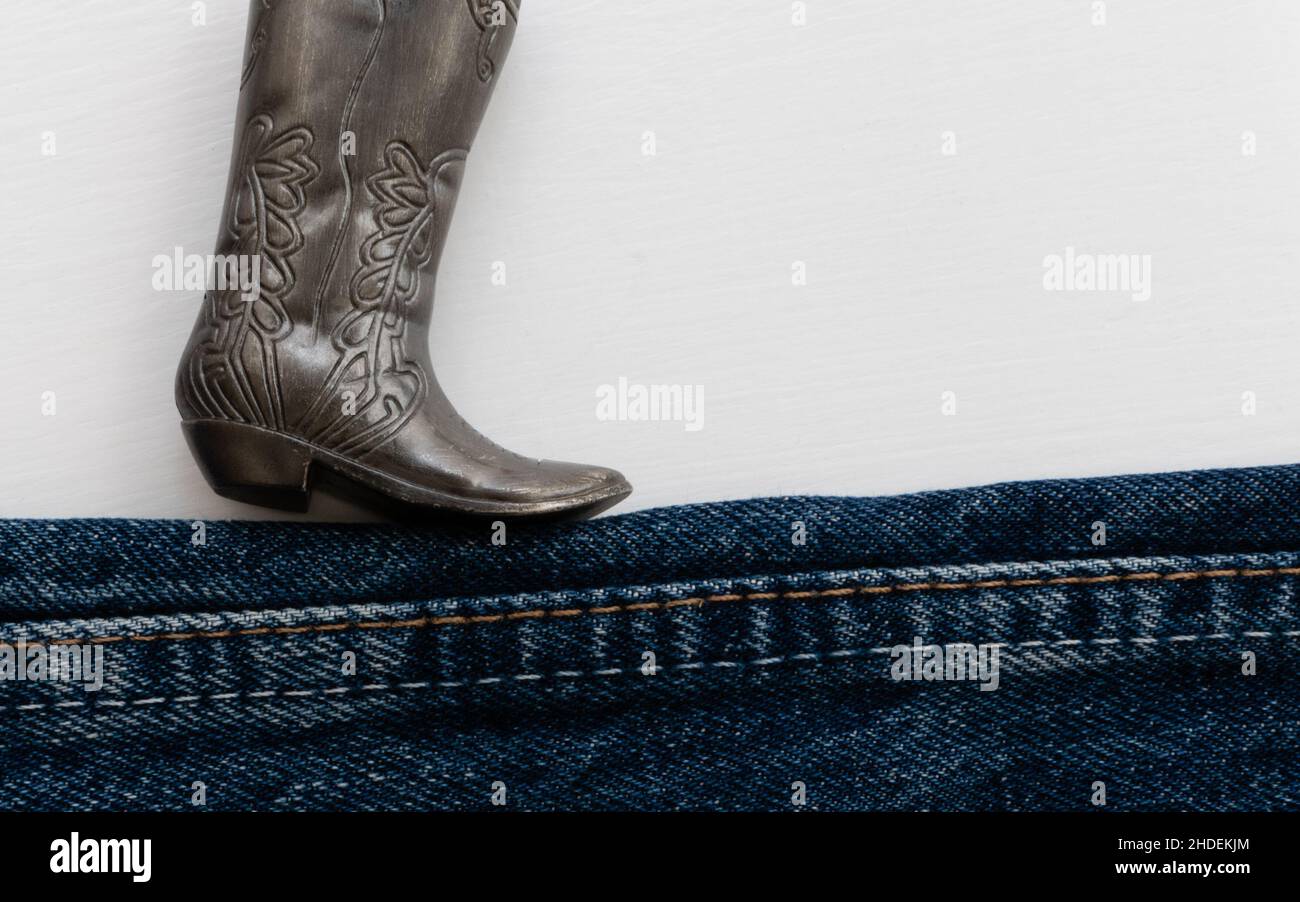 Vintage metal boot close-up on denim fabric with double stitching on ...