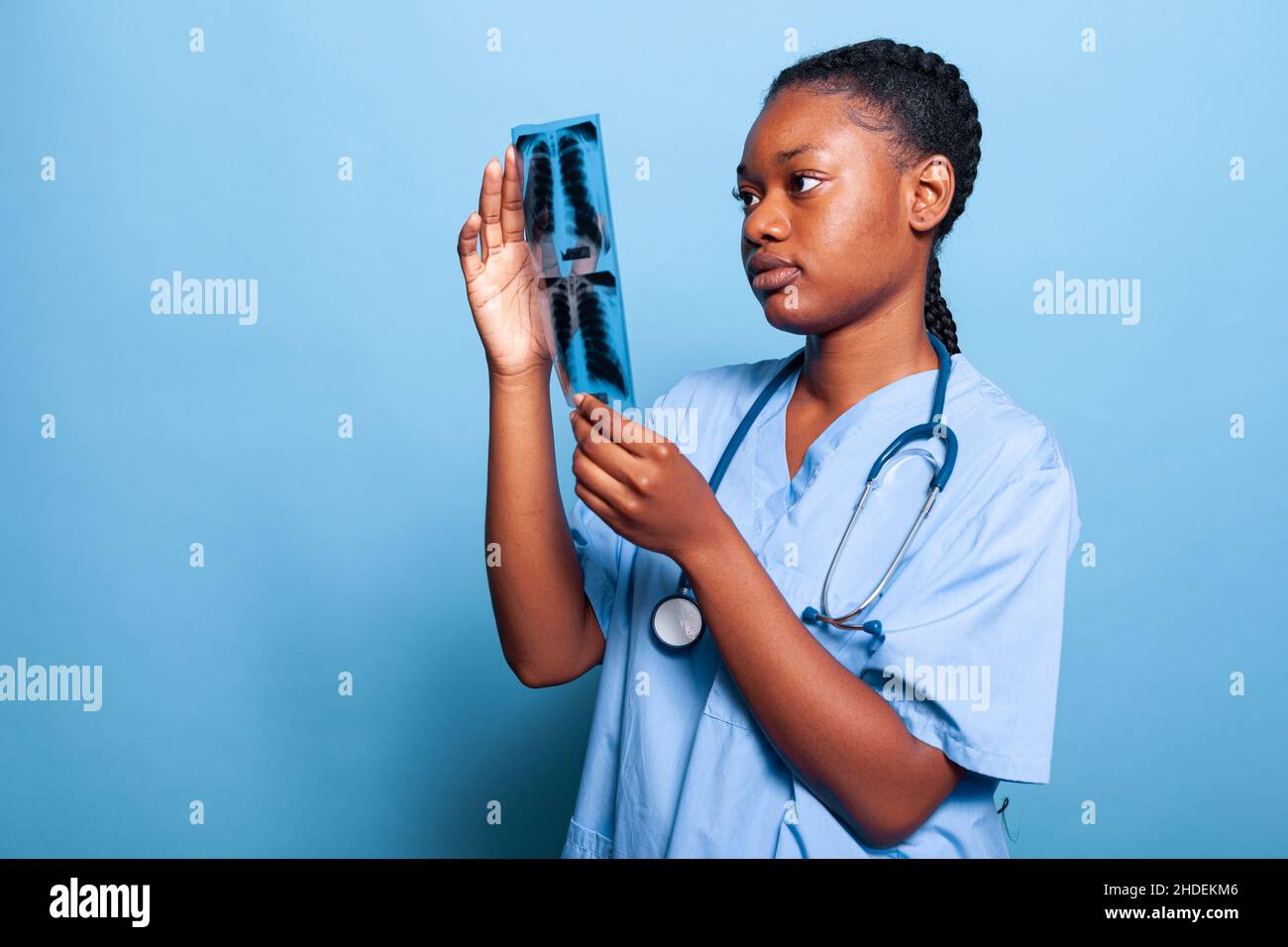 African american specialist nurse holding radiography analyzing lungs ...