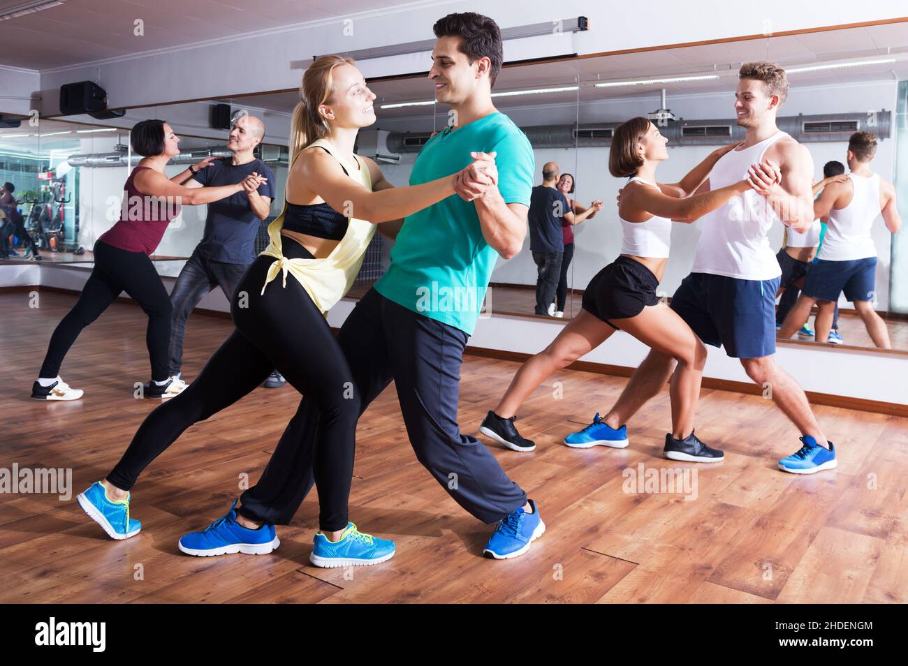 Dancing couples learning salsa Stock Photo - Alamy