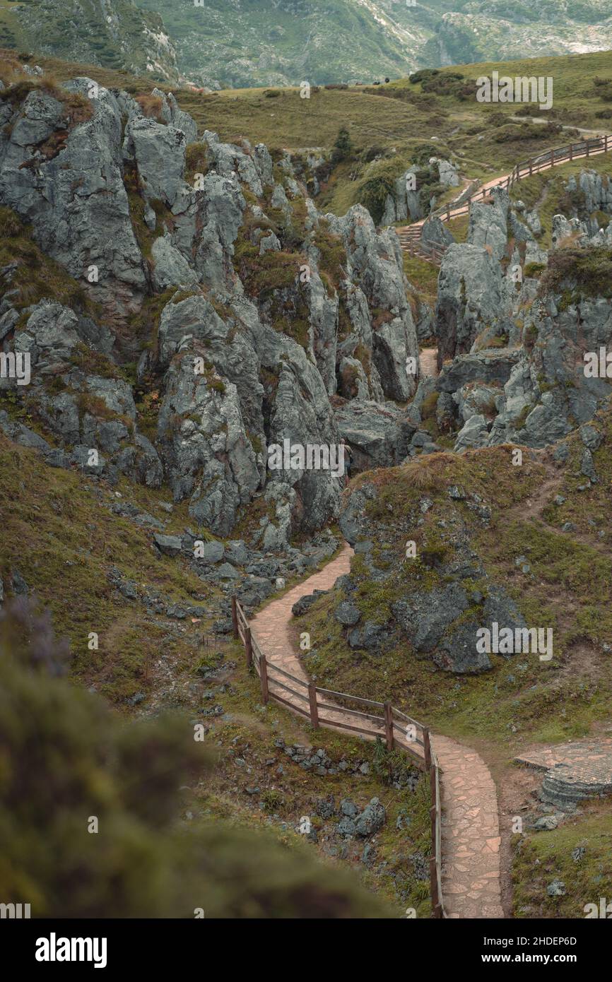 Vertical shot of a pathway surrounded with hills Stock Photo - Alamy