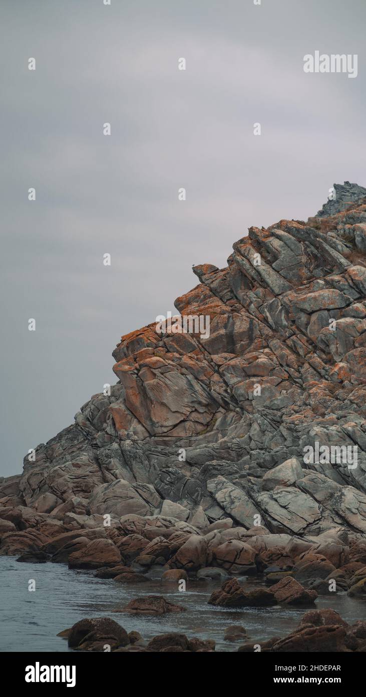 Vertical shot of cliffs under the cloudy skies Stock Photo - Alamy