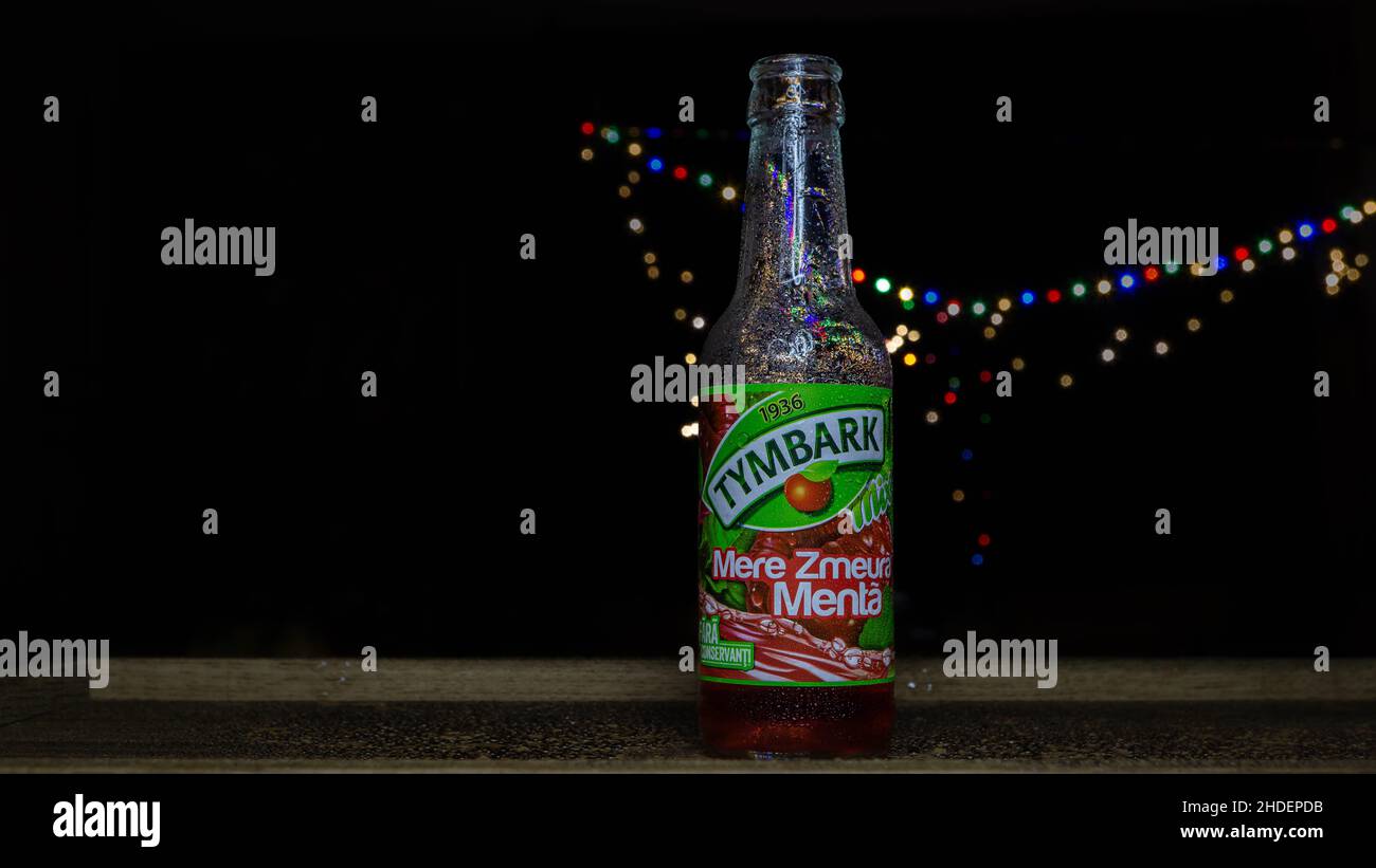 Closeup of a cold Tymbark glass with apple juice isolated on a black ...