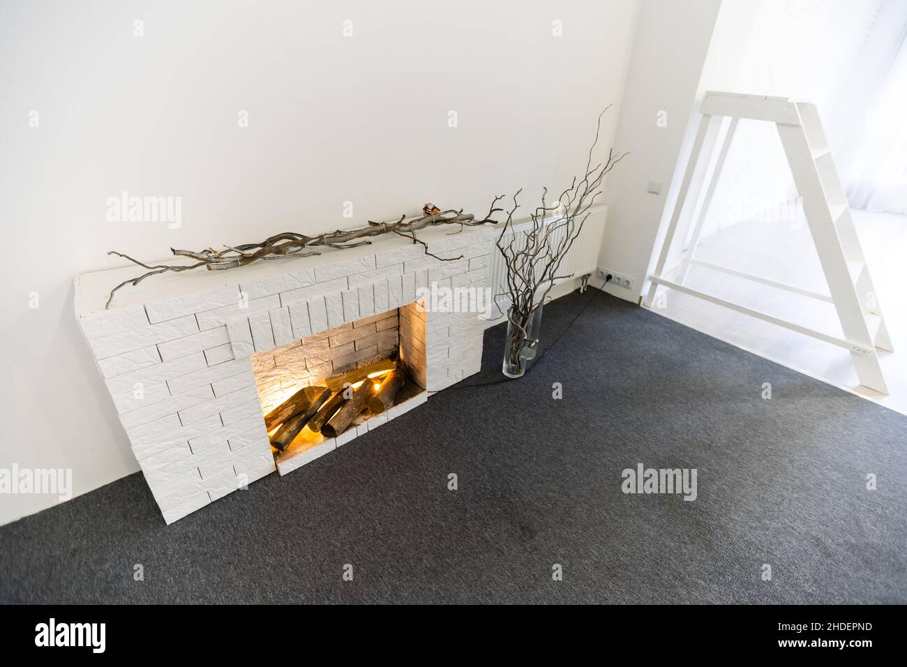 Decorative fake fireplace in room Stock Photo - Alamy
