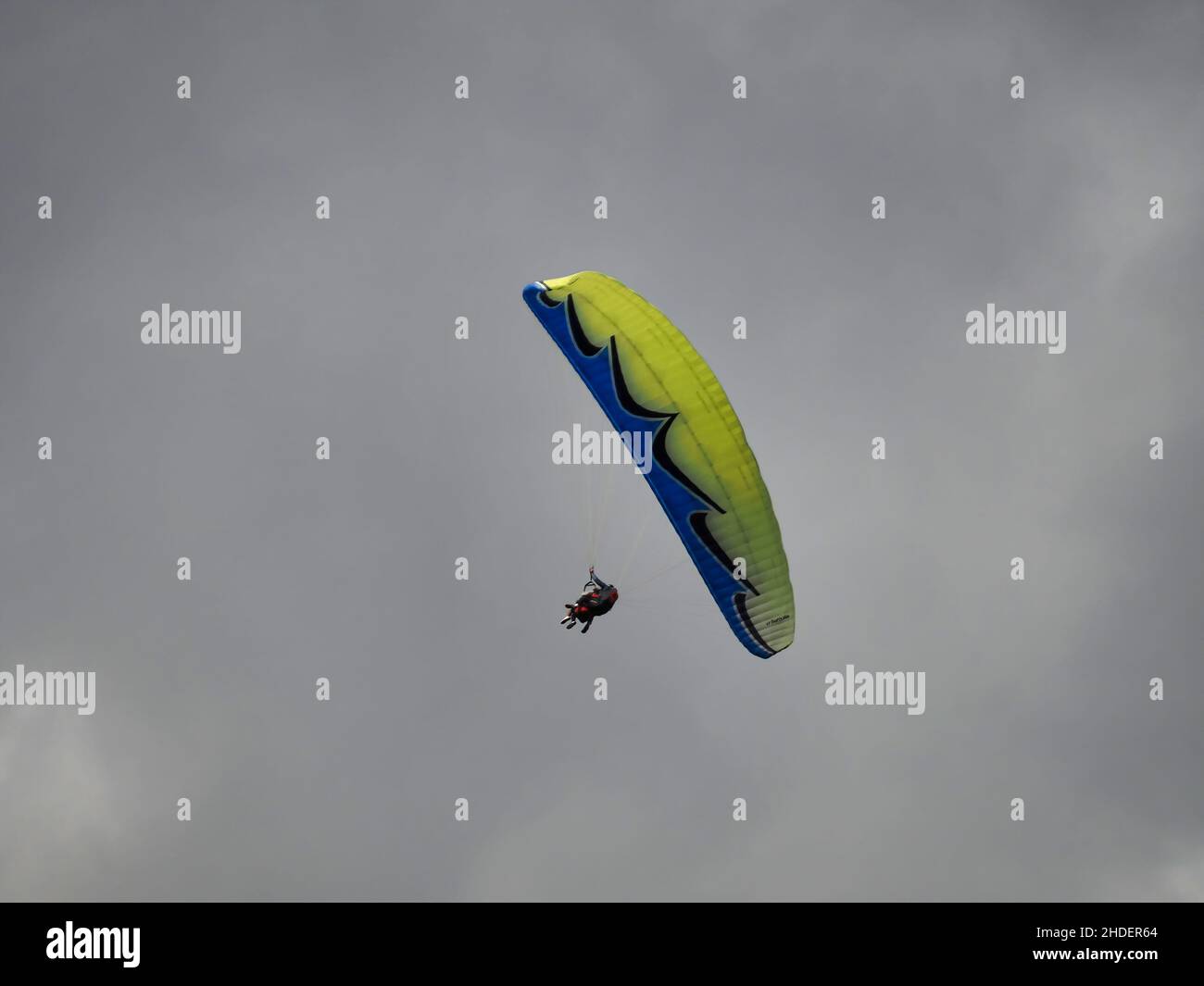 View of colorful paraglider flying in the sky against the background of ...