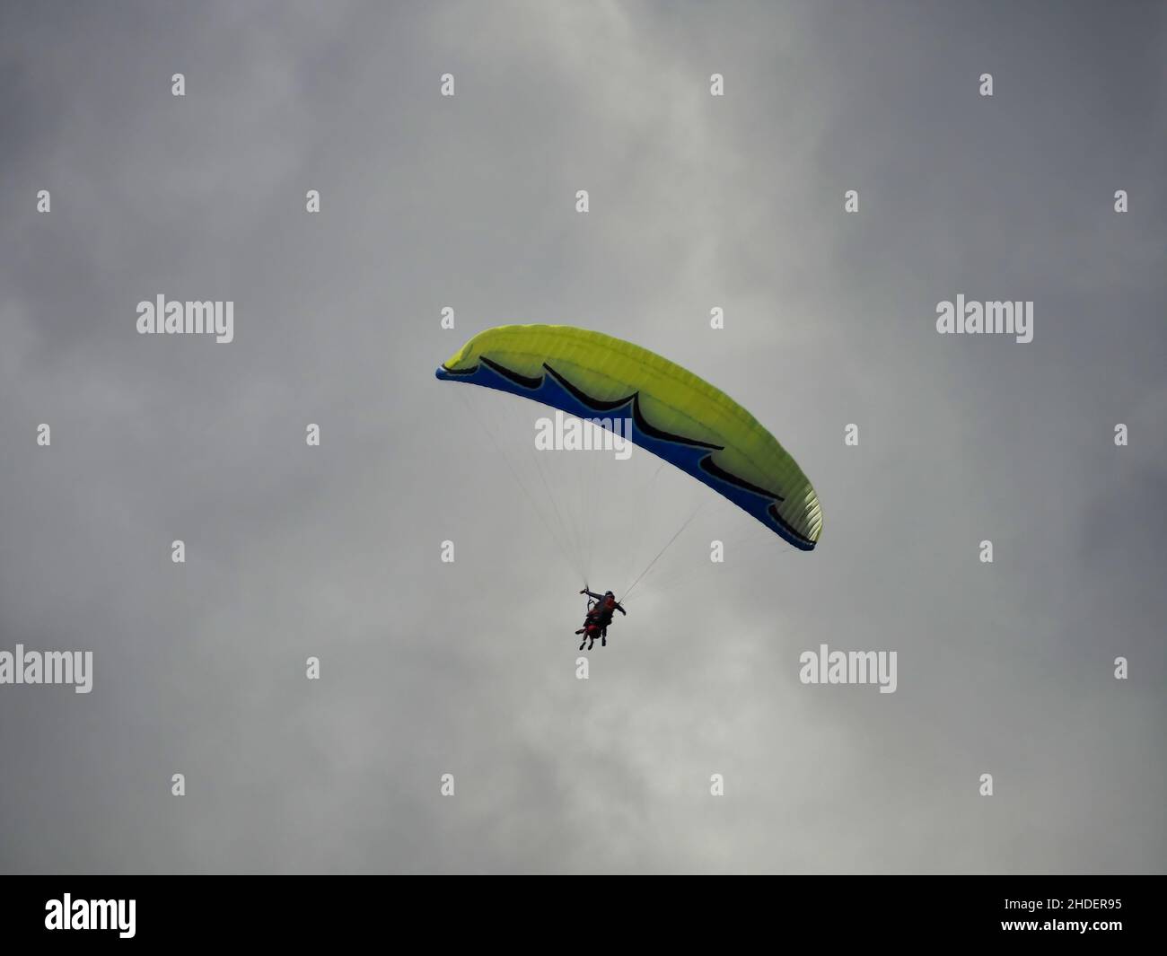 View of colorful paraglider flying in the sky against the background of ...