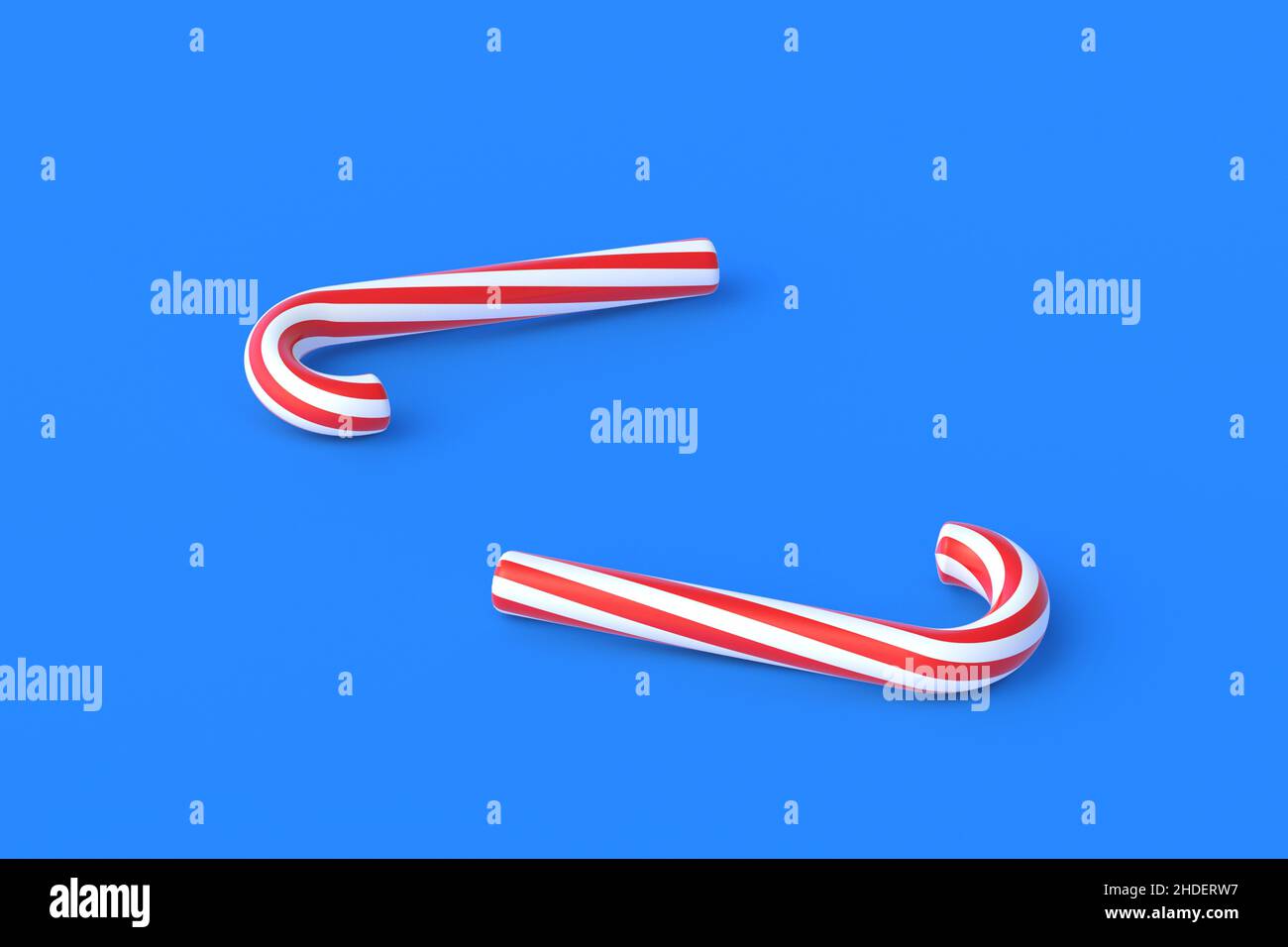 Christmas canes, candy with red stripes on blue background. New Years ...