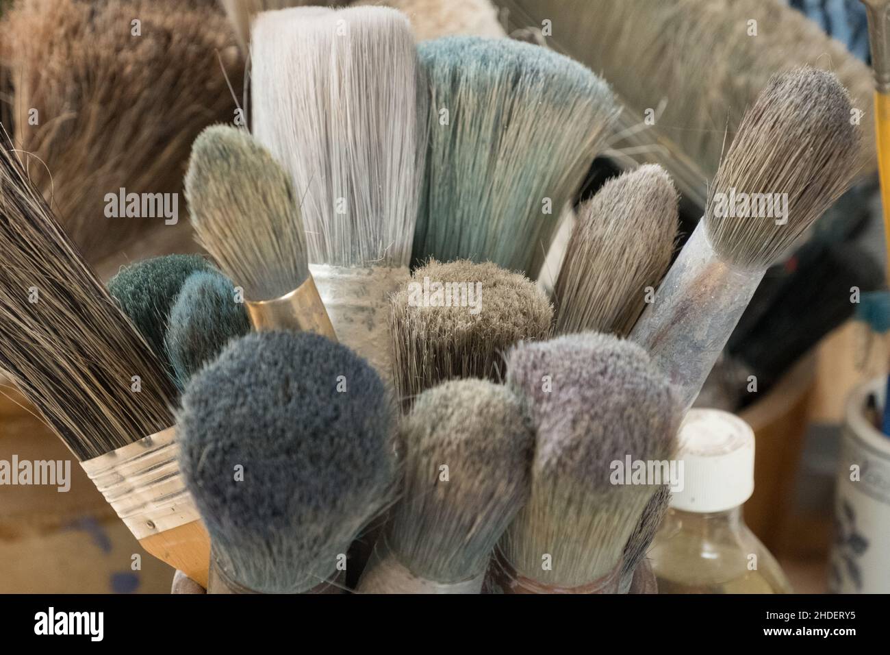 Used paint brushes in a holder Stock Photo - Alamy
