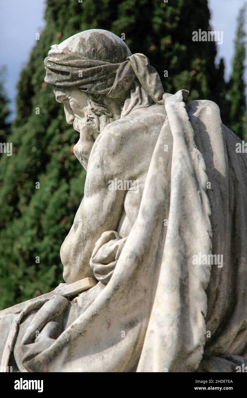 Statue of a young grieving man at the Monumental Cemetery of Staglieno ...
