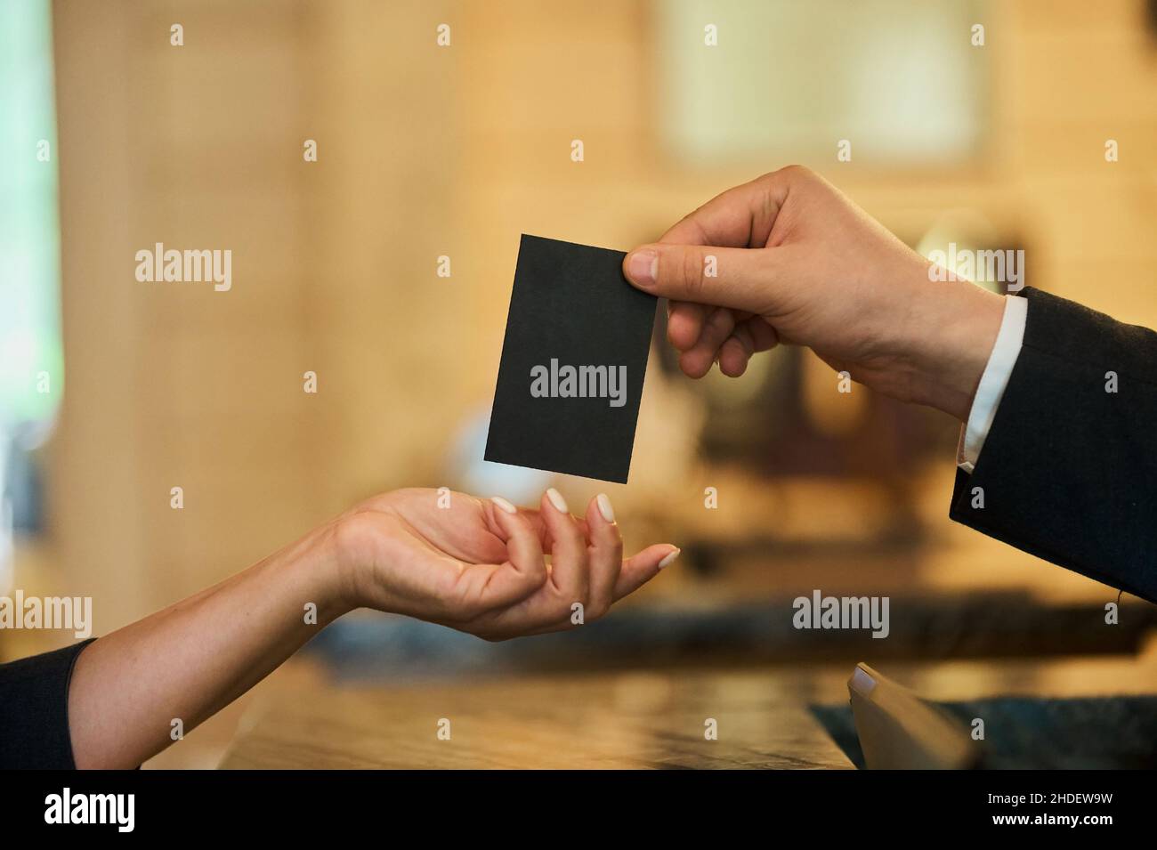 Woman handing over credit card at cash register Stock Photo - Alamy