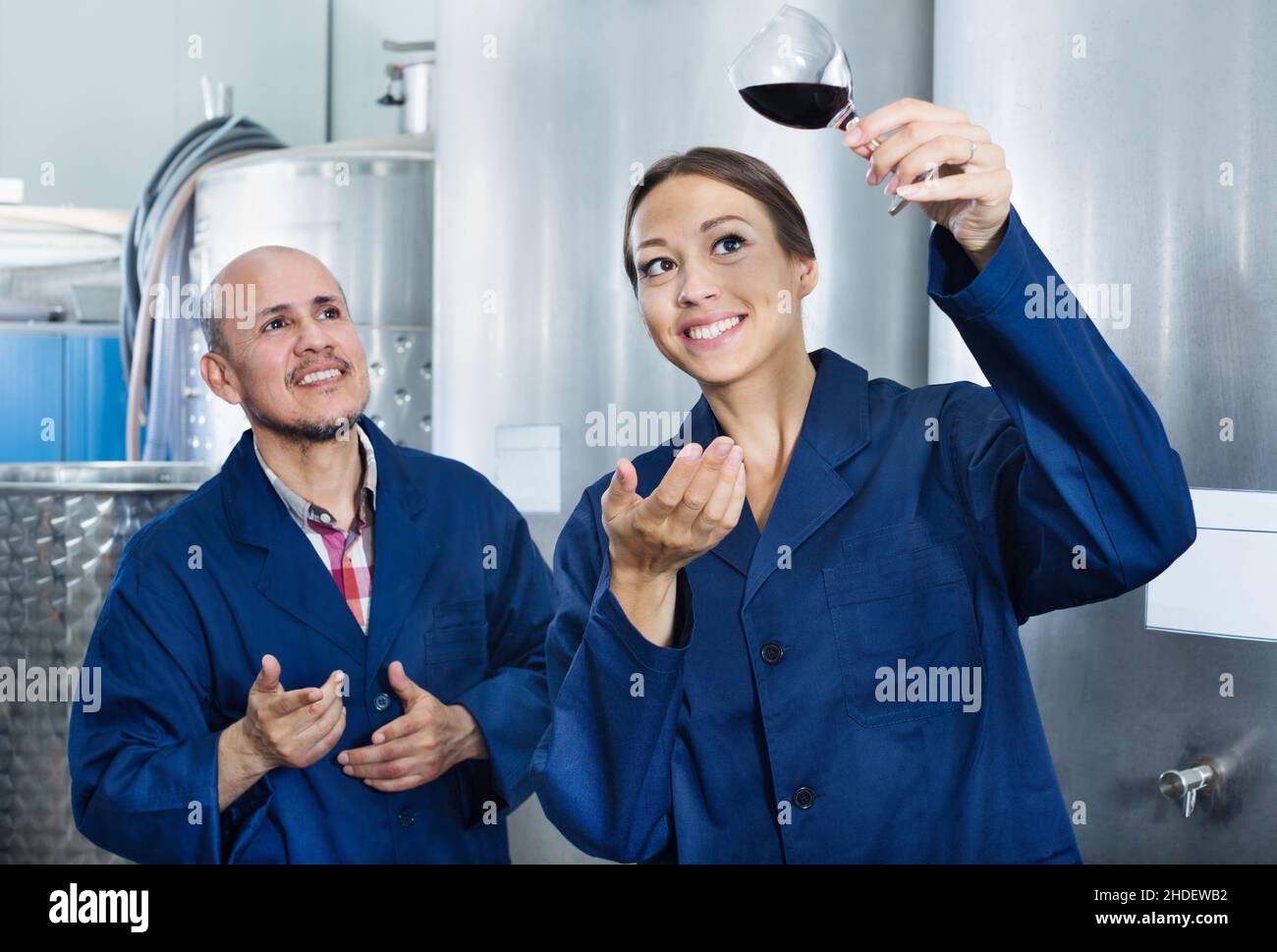 Winery workers holding glass in wine factory Stock Photo - Alamy
