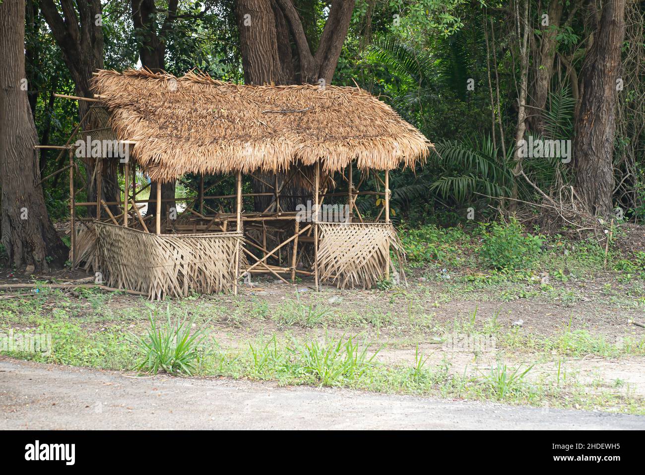A straw hut without walls on the edge of the jungle. Selective focus ...