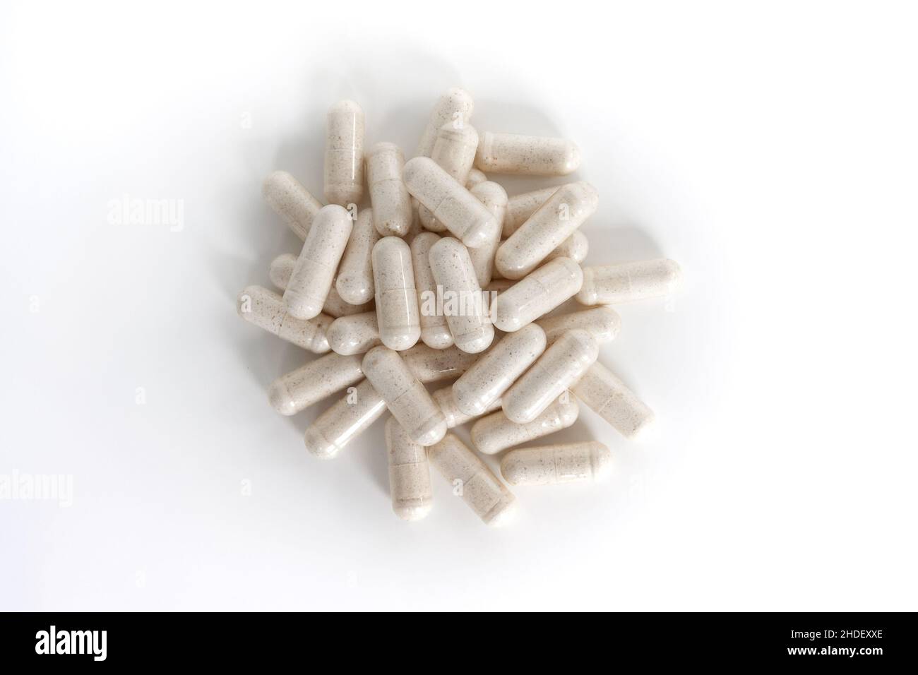 A pile of white multivitamin supplements from above isolated on white ...