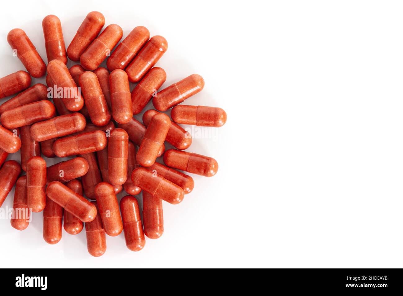 Top view detail of red vitamin supplements isolated on a white ...