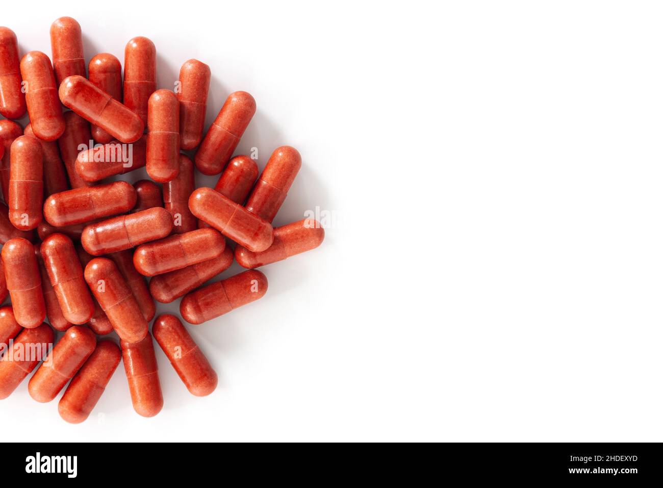 Red vitamin supplements detail from above isolated on a white ...
