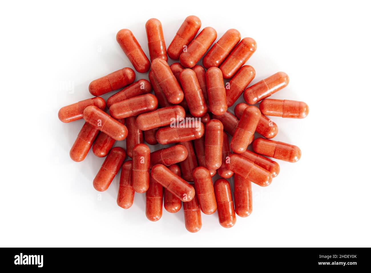 Red vitamin supplements from above isolated on a white background Stock ...