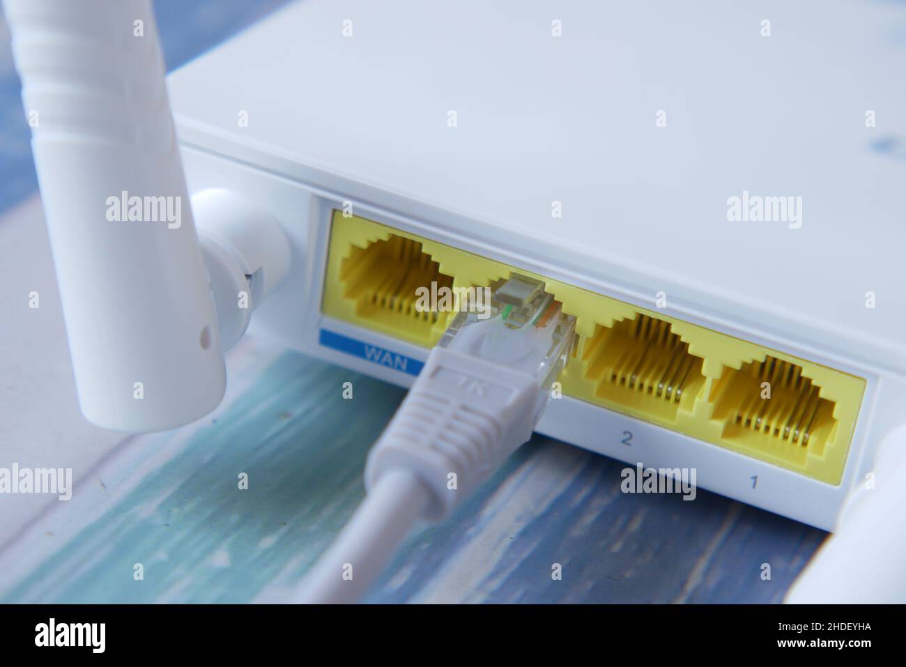 Wi-Fi router with cables on table Stock Photo - Alamy