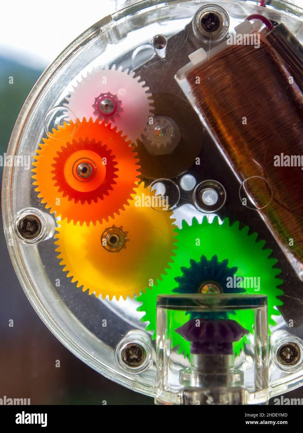 Macro photography of the cog mechanism of a rainbow maker machine glued ...