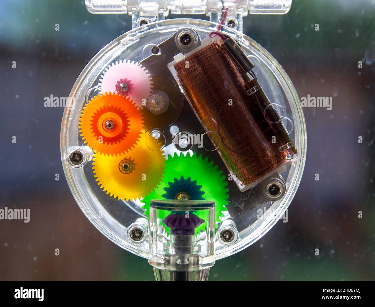 Macro photography of the cog mechanism of a rainbow maker machine glued ...