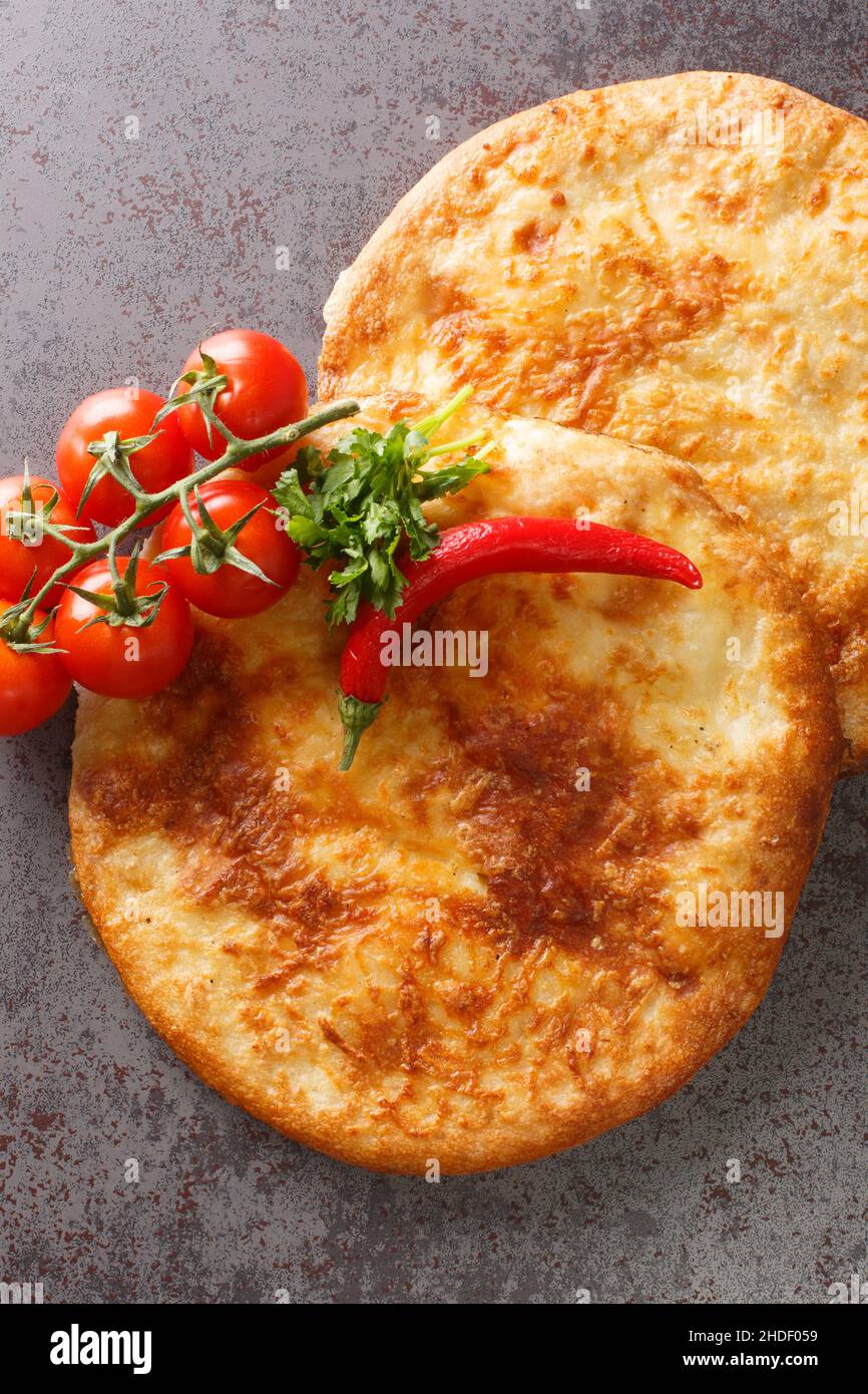 Georgian flat bread khachapuri with cheese close-up on the table ...