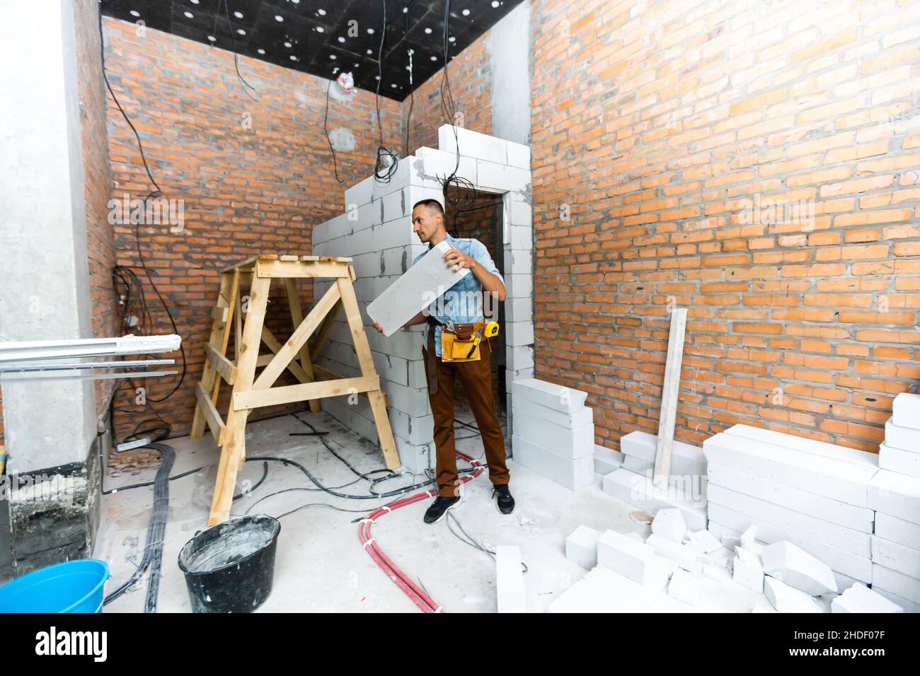 Repairman inside a house under construction. construction worker ...
