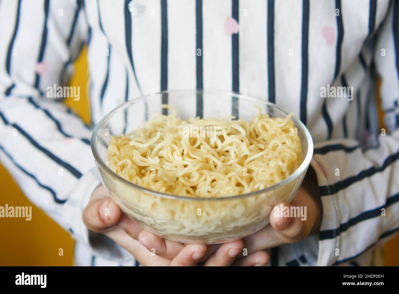 boy eating noodles in a bowl Stock Photo - Alamy