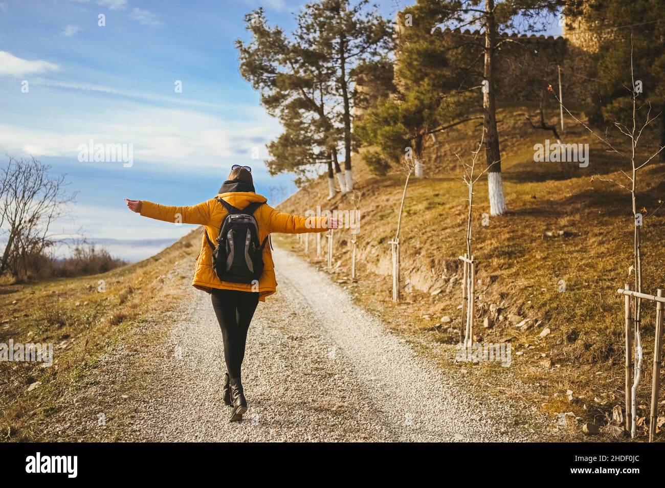 Backpacker woman tourist traveling alone and posing at dawn with fog on ...