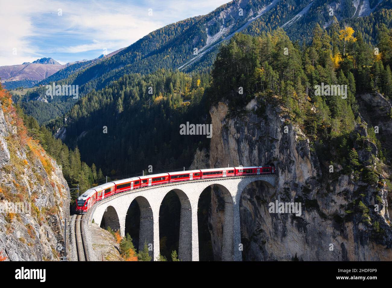 Passenger train through Landwasser Viaduct in the Swiss Alps ...