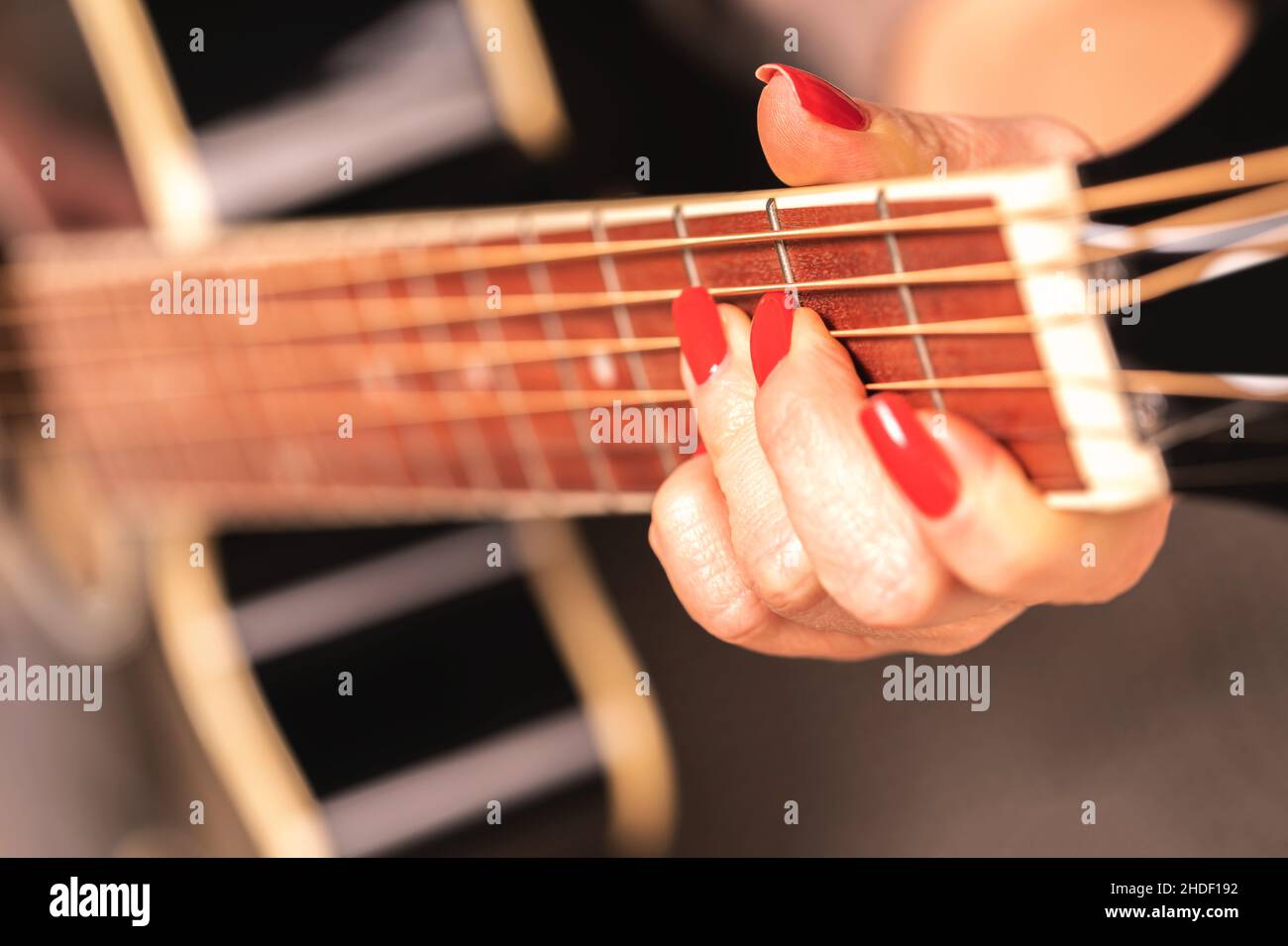 woman playing guitar, hands on strings close up Stock Photo - Alamy