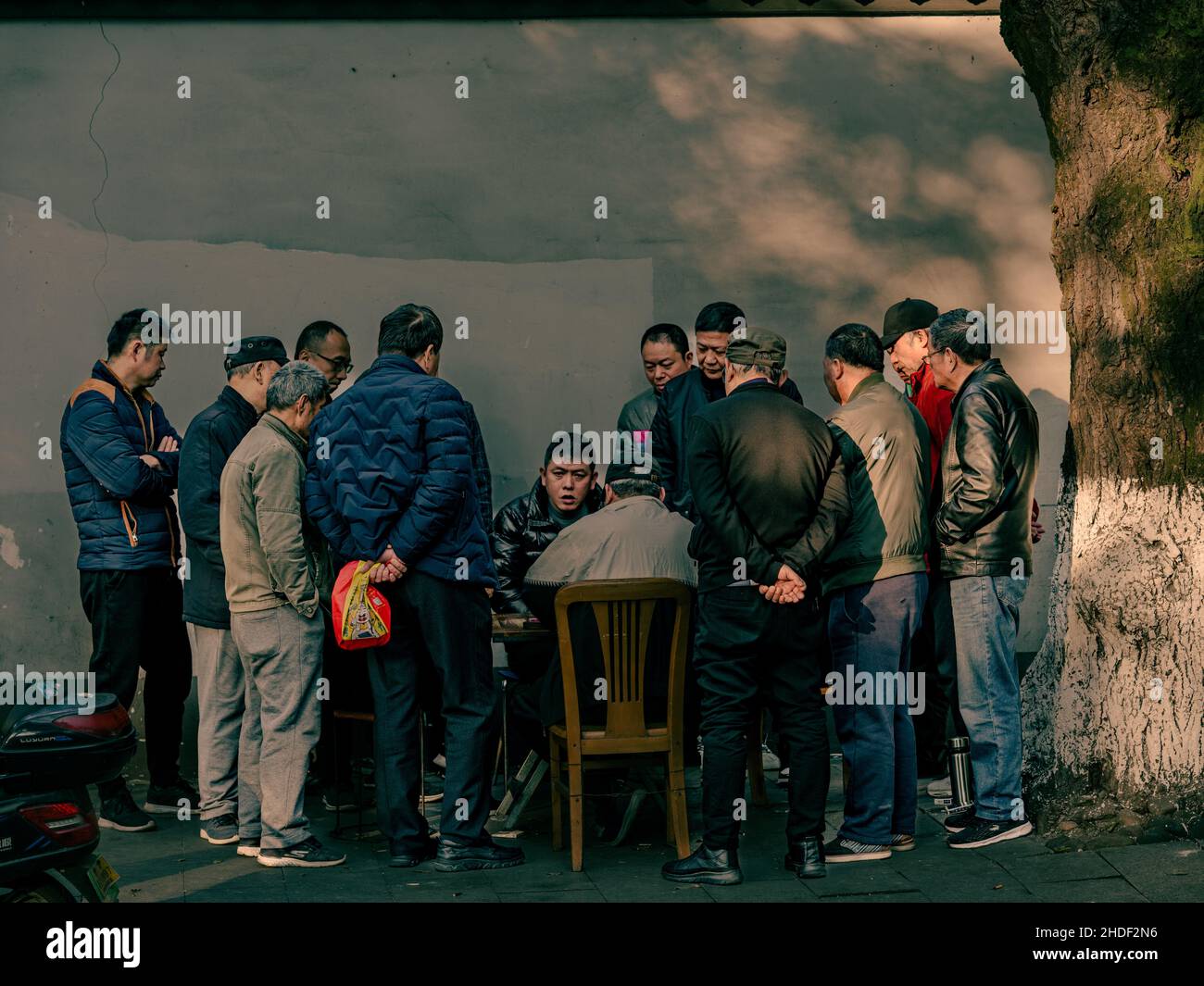 A group of people standing around a table hi-res stock photography and ...