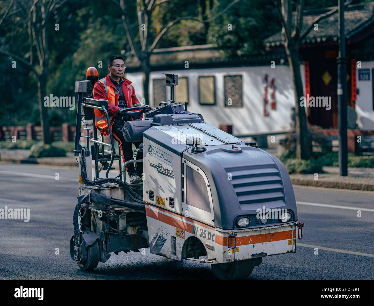 Male worker riding a street cleaning machine in Hangzhou, China Stock ...