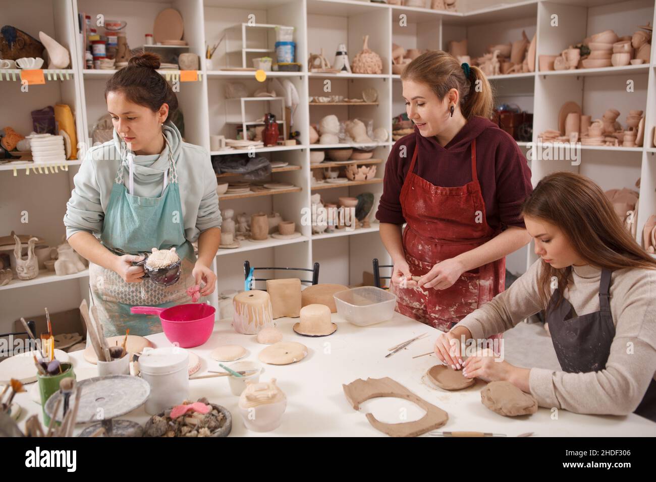Three women working at ceramics studio Stock Photo - Alamy