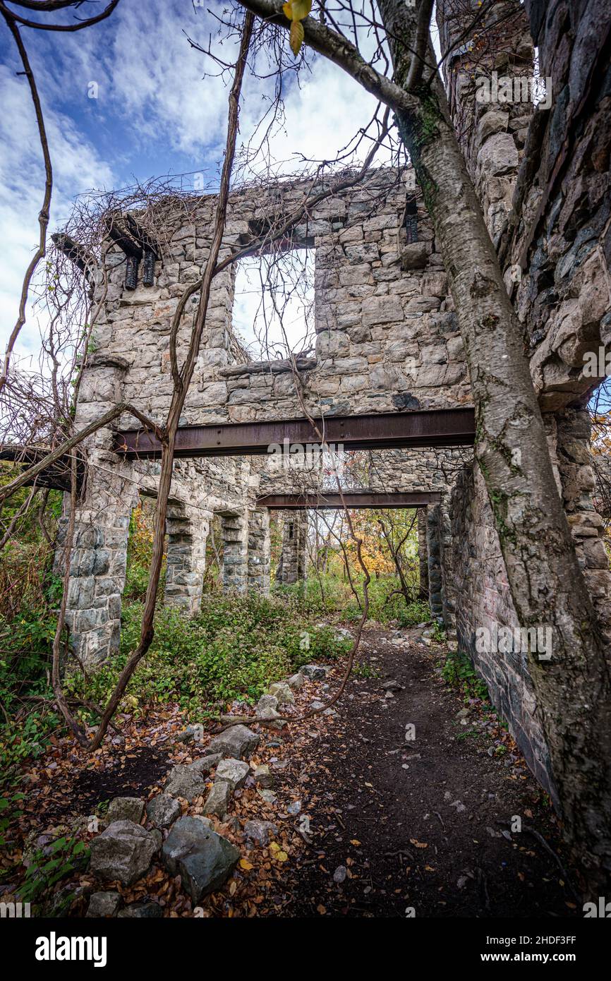 Vertical shot of an old abandoned ruin stone building under a cloudy ...