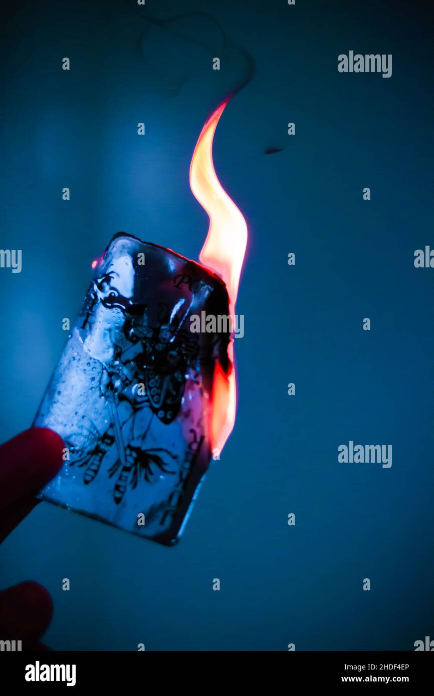 Vertical shot of a burning joker playing card Stock Photo - Alamy