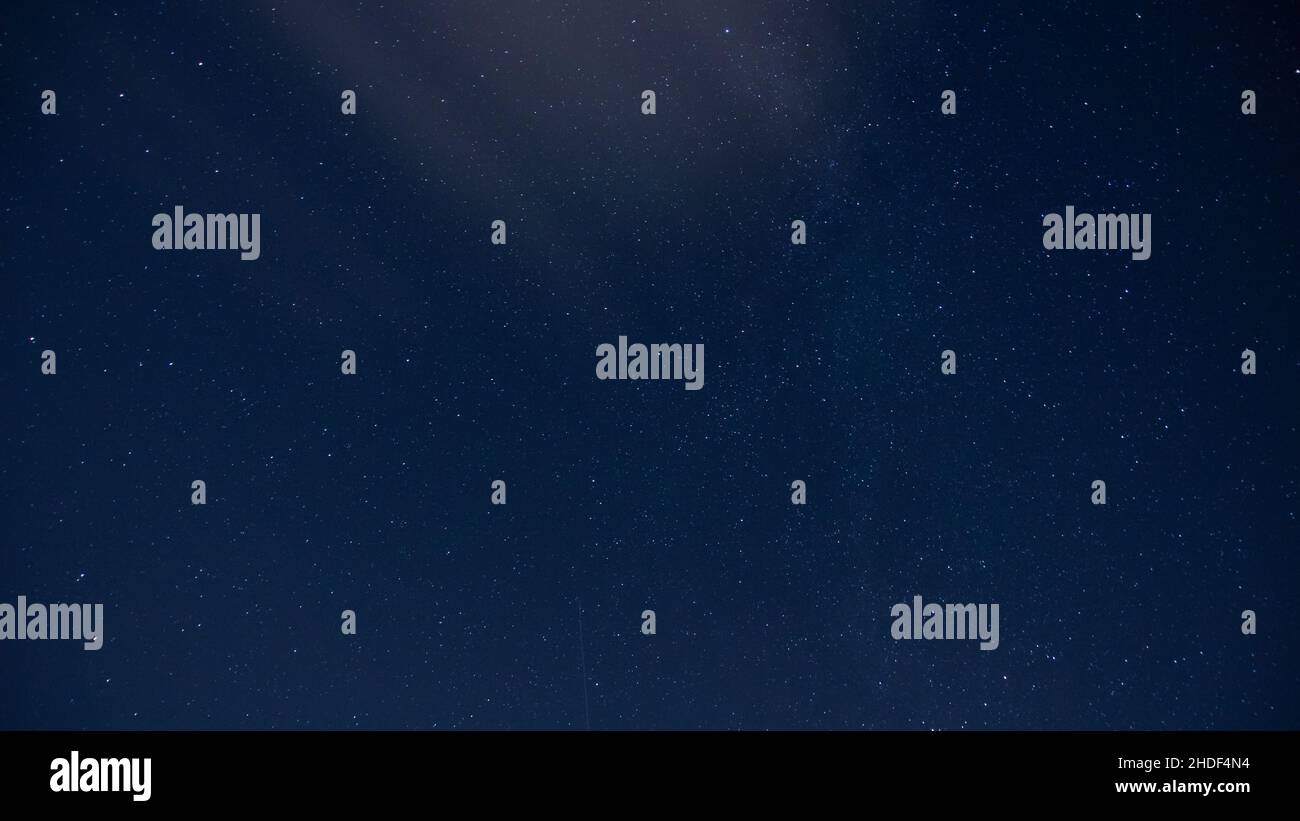 Beautiful view of motion light in blue night sky and stars on dark ...