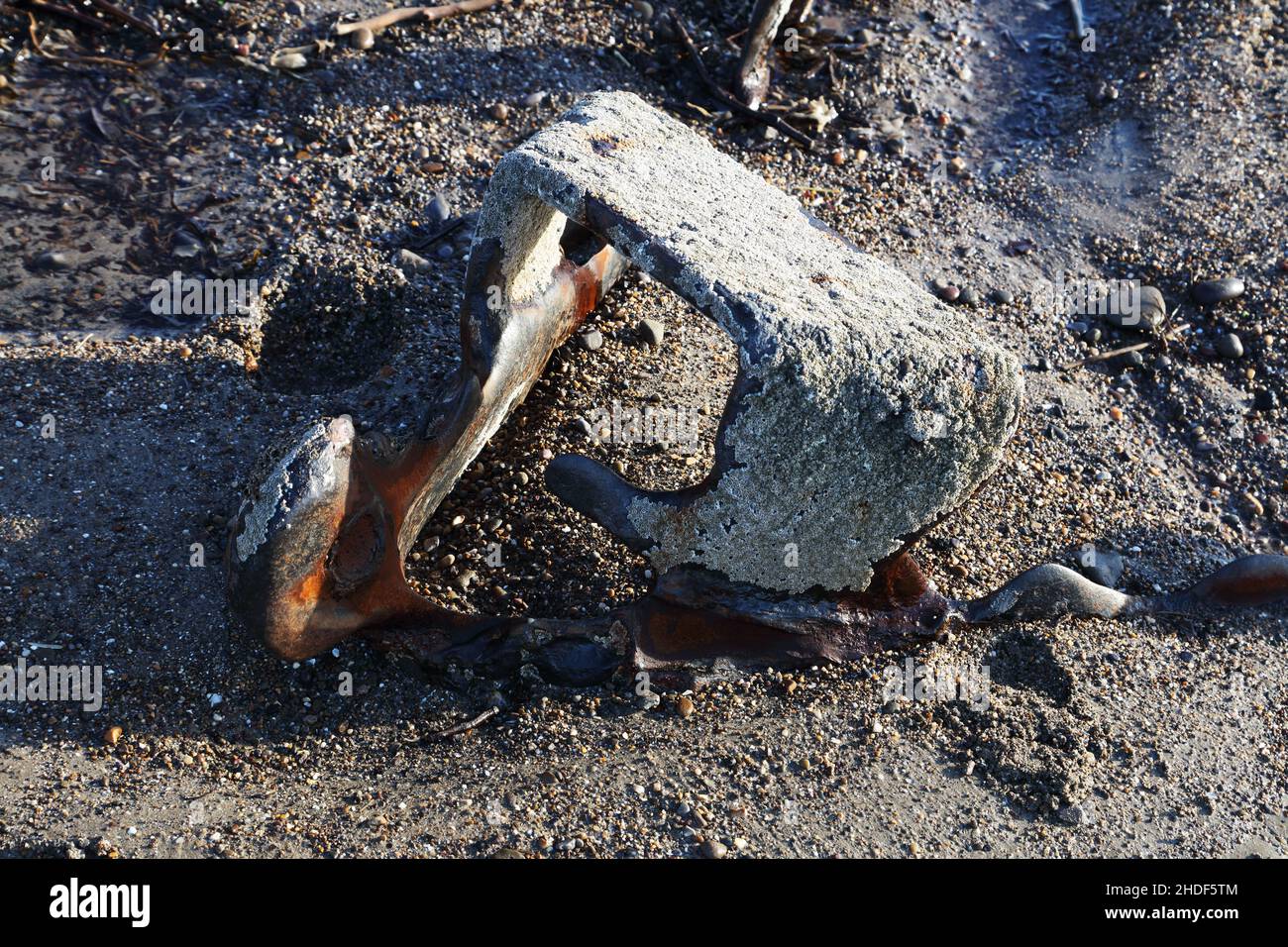 The rusty remains of the front end of a steel framed boat lying at the ...