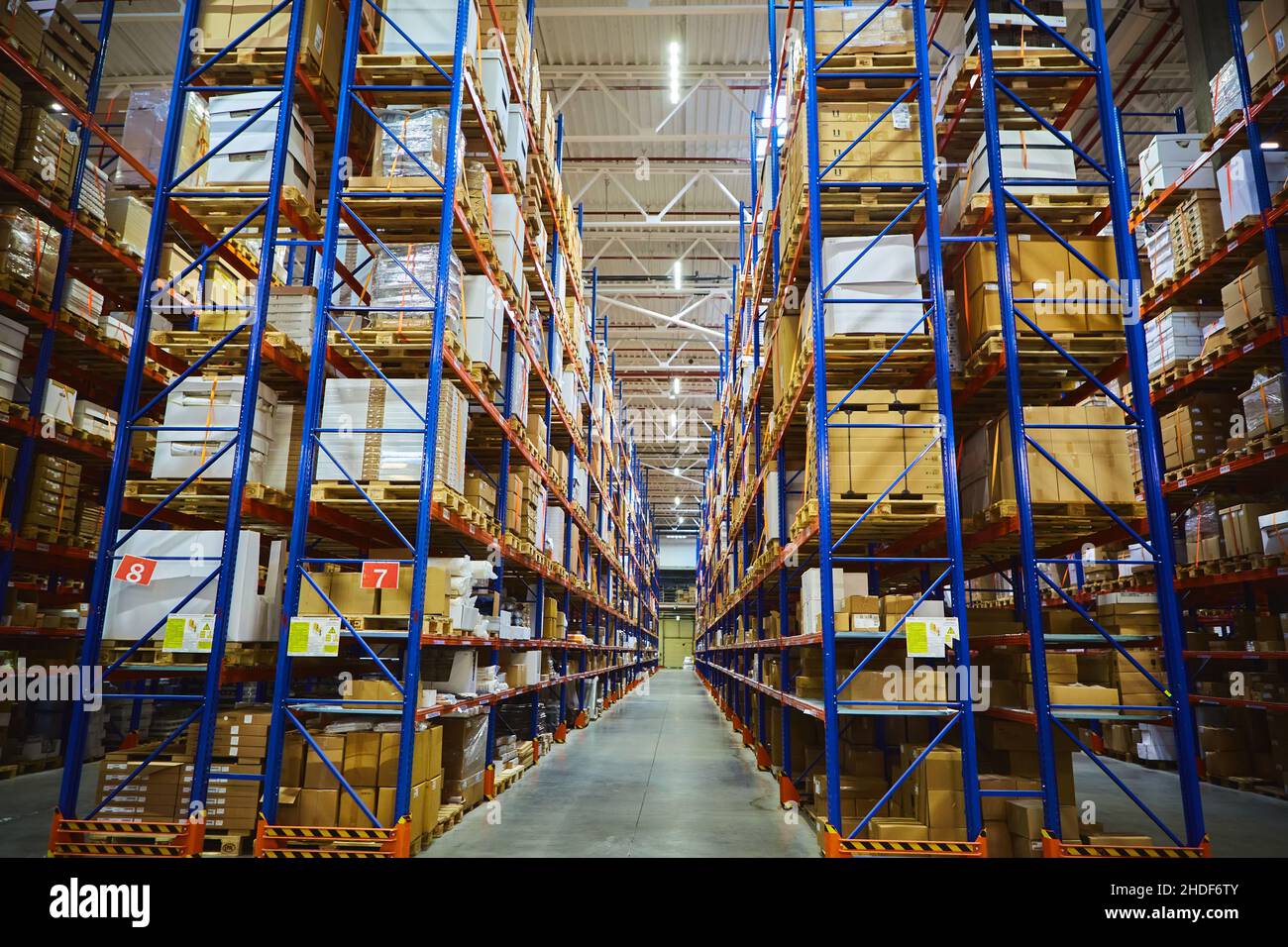 Interior of a modern warehouse storage of retail shop with pallet truck ...