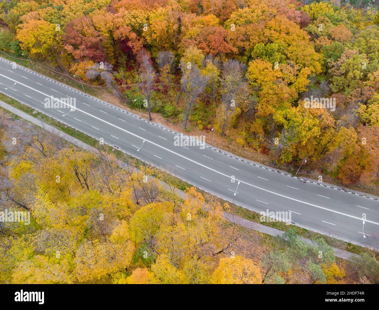 Look down on driveway street in autumn city park. Aerial on scenic ...