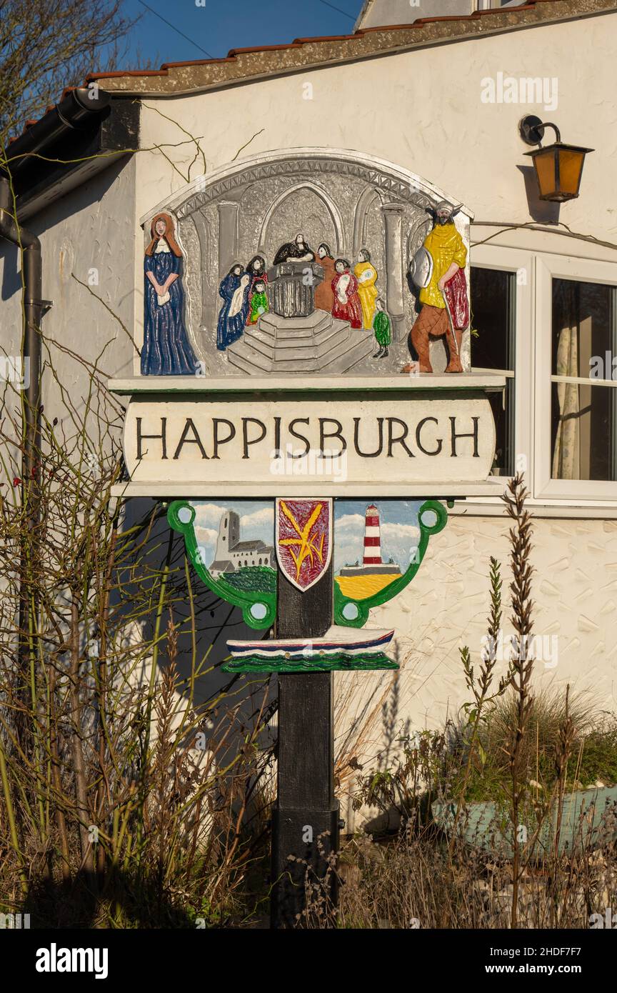 A view of Happisburgh village sign depicting figures and landmarks from ...