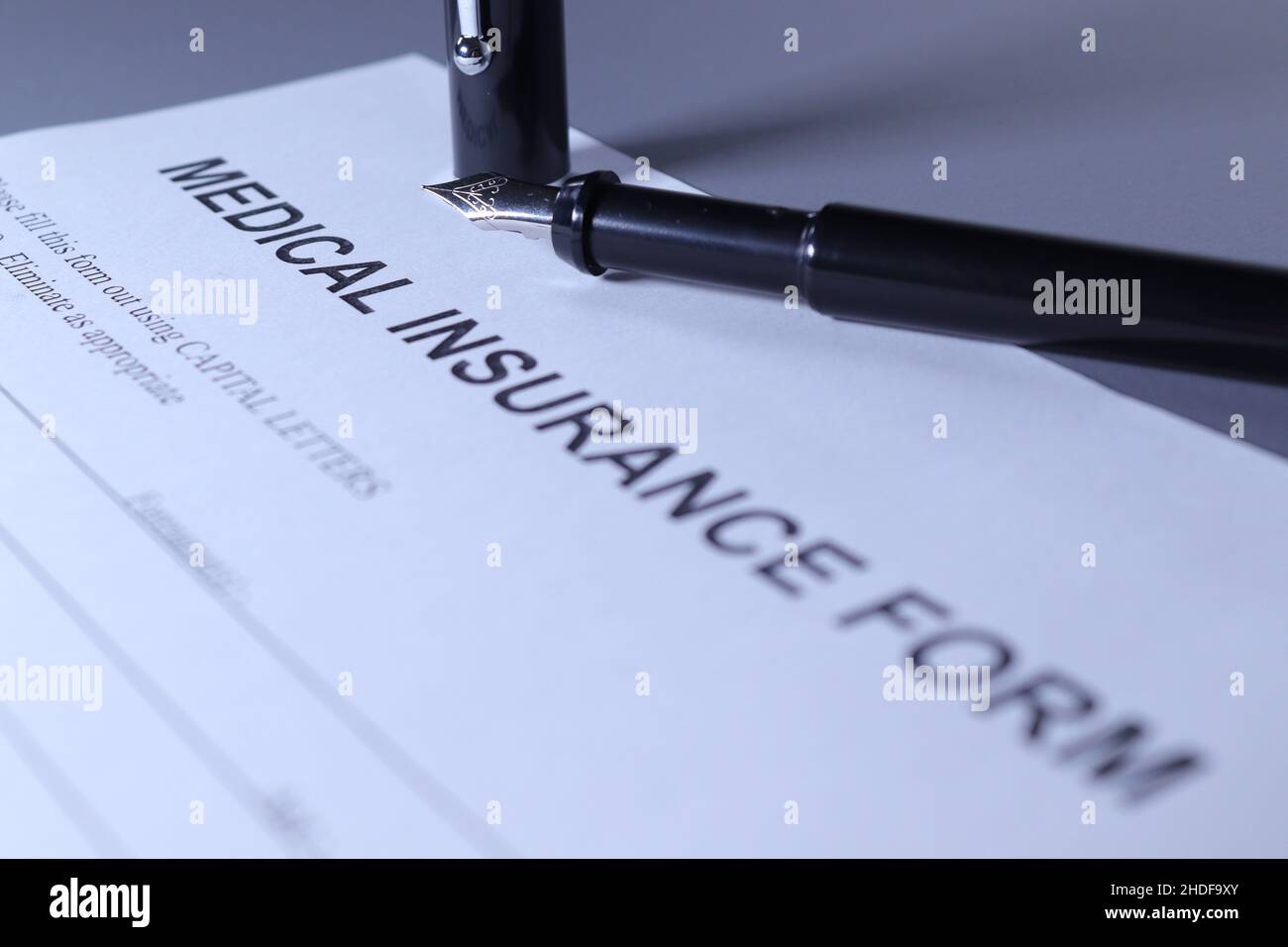 Medical Insurance Form with fountain pen lain across the top of the ...
