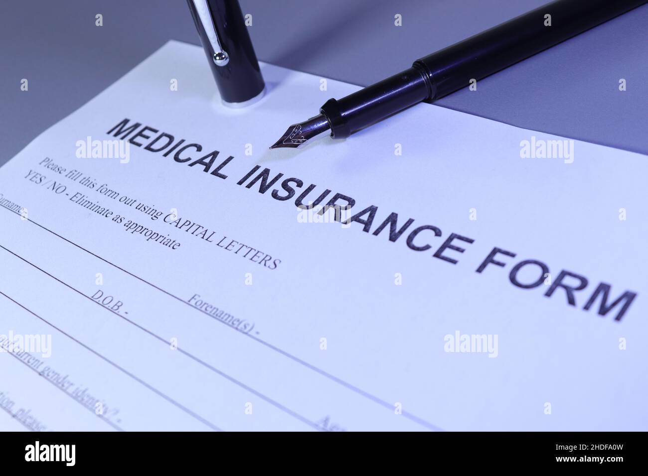 Medical Insurance Form with fountain pen lain across the top of the ...