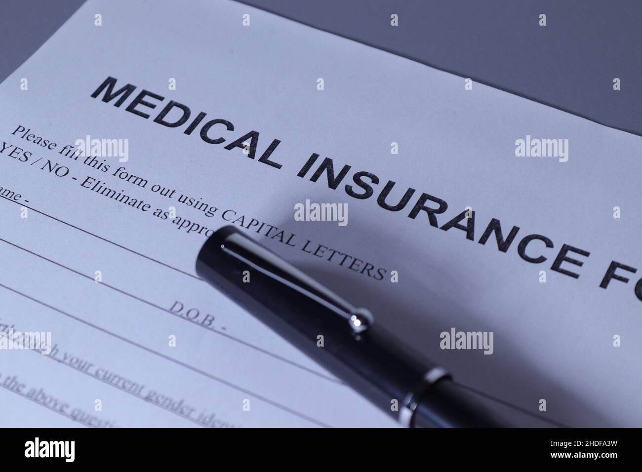 Medical Insurance Form with fountain pen lain across the top of the ...