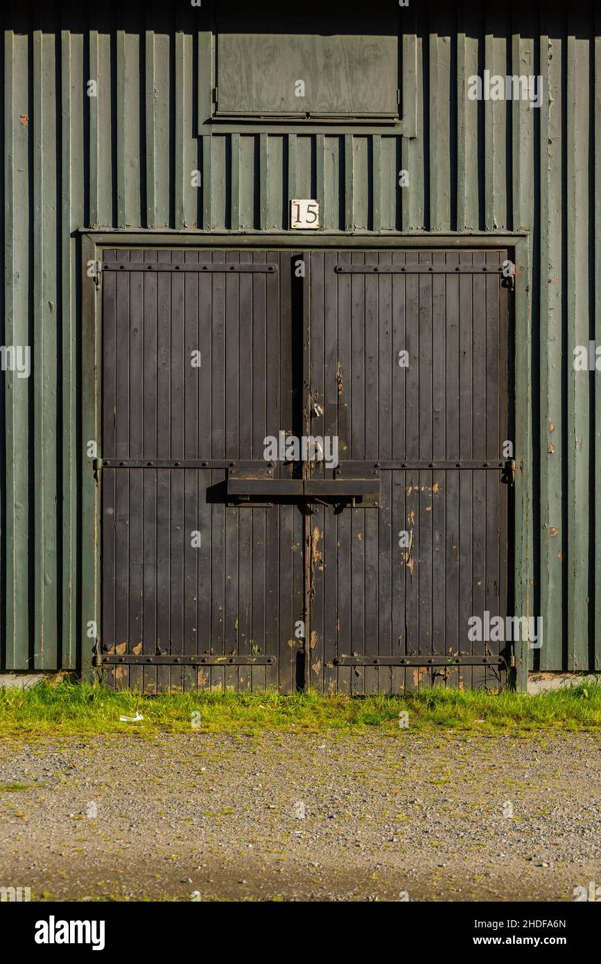 Bolted and shut door on a green storage shed Stock Photo - Alamy