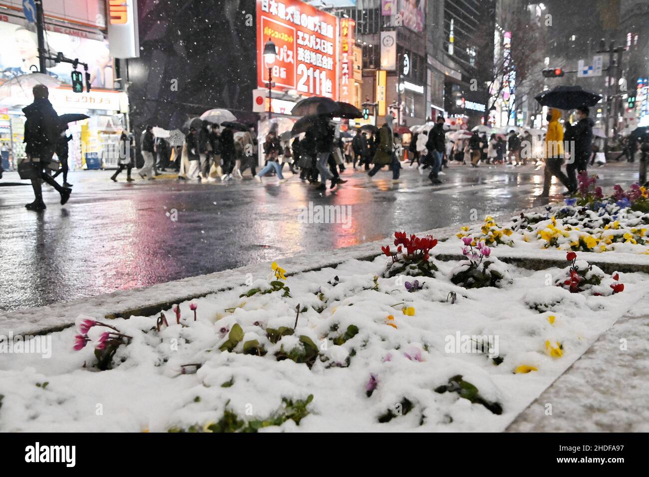 Tokyo, Japan. 06th Jan, 2022. Pedestrians walk across the Shibuya ...