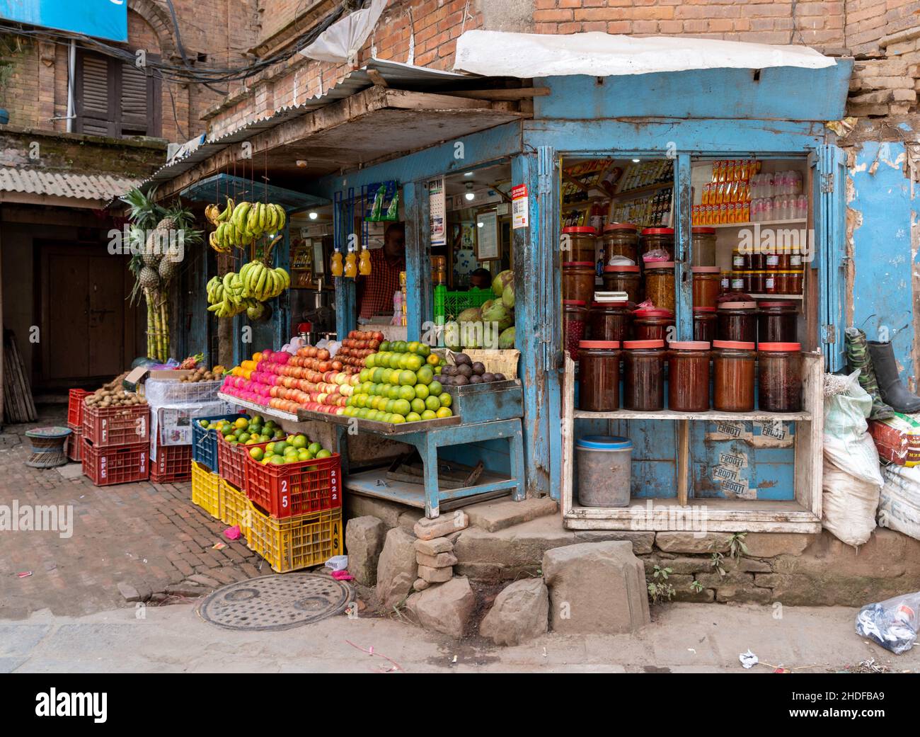 A small corner stand with fresh fruit and pickle or achaar for sale ...