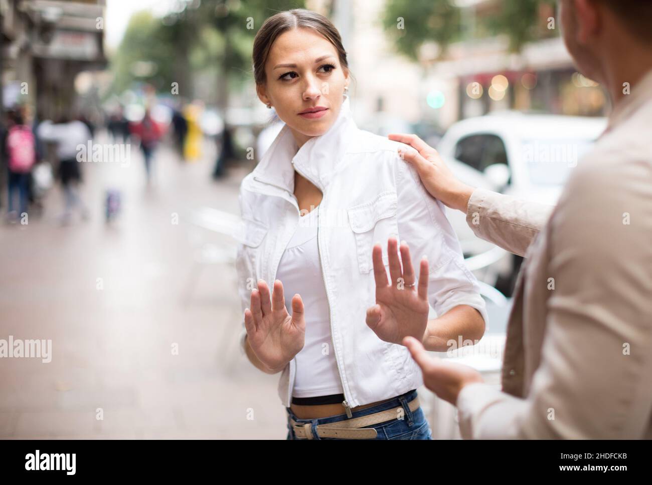 Angry woman getting rid of unwelcome stranger Stock Photo - Alamy