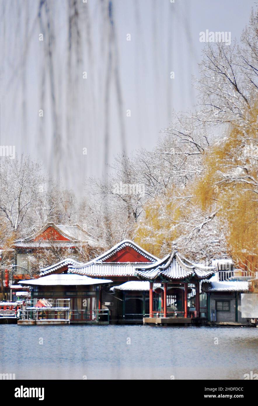 Vertical shot of a Houhai lake with buildings in winter in Beijing ...