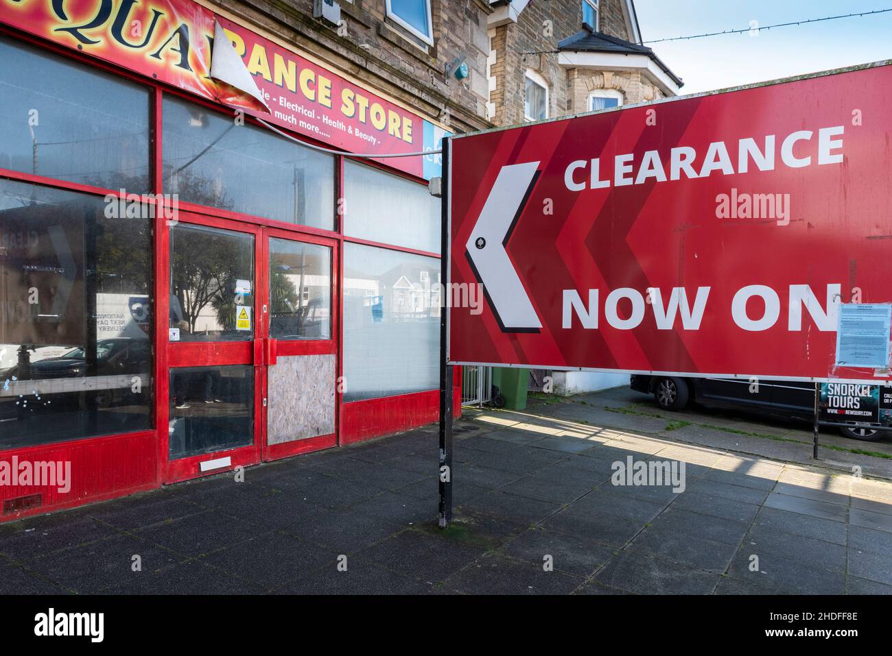 A large clearance sign outside a closed and derelict shop in Newquay ...