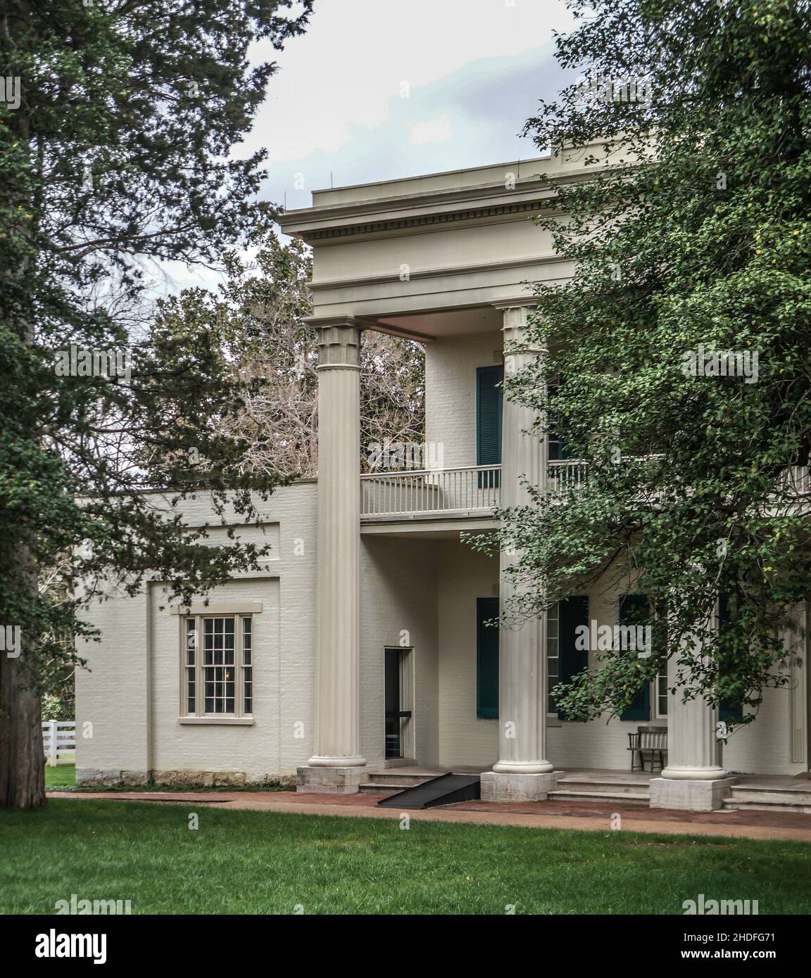 Beautiful white building with columns behind the trees Stock Photo - Alamy