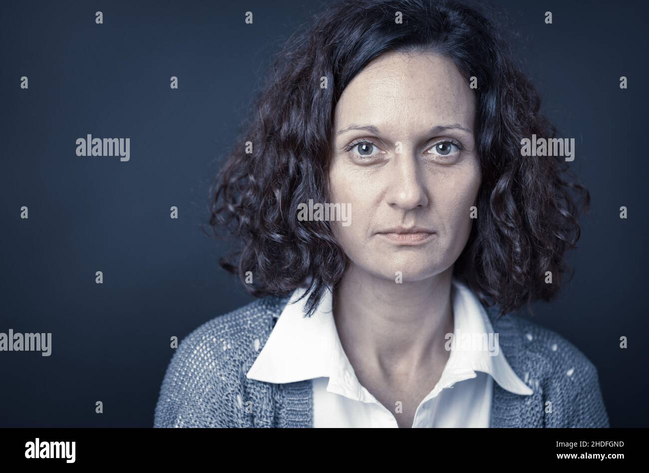Dark hair 40s woman serious hi-res stock photography and images - Alamy